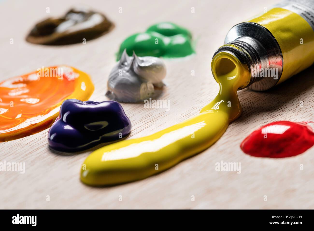 Assorted paint colors and tube on a wooden palette, close up Stock ...