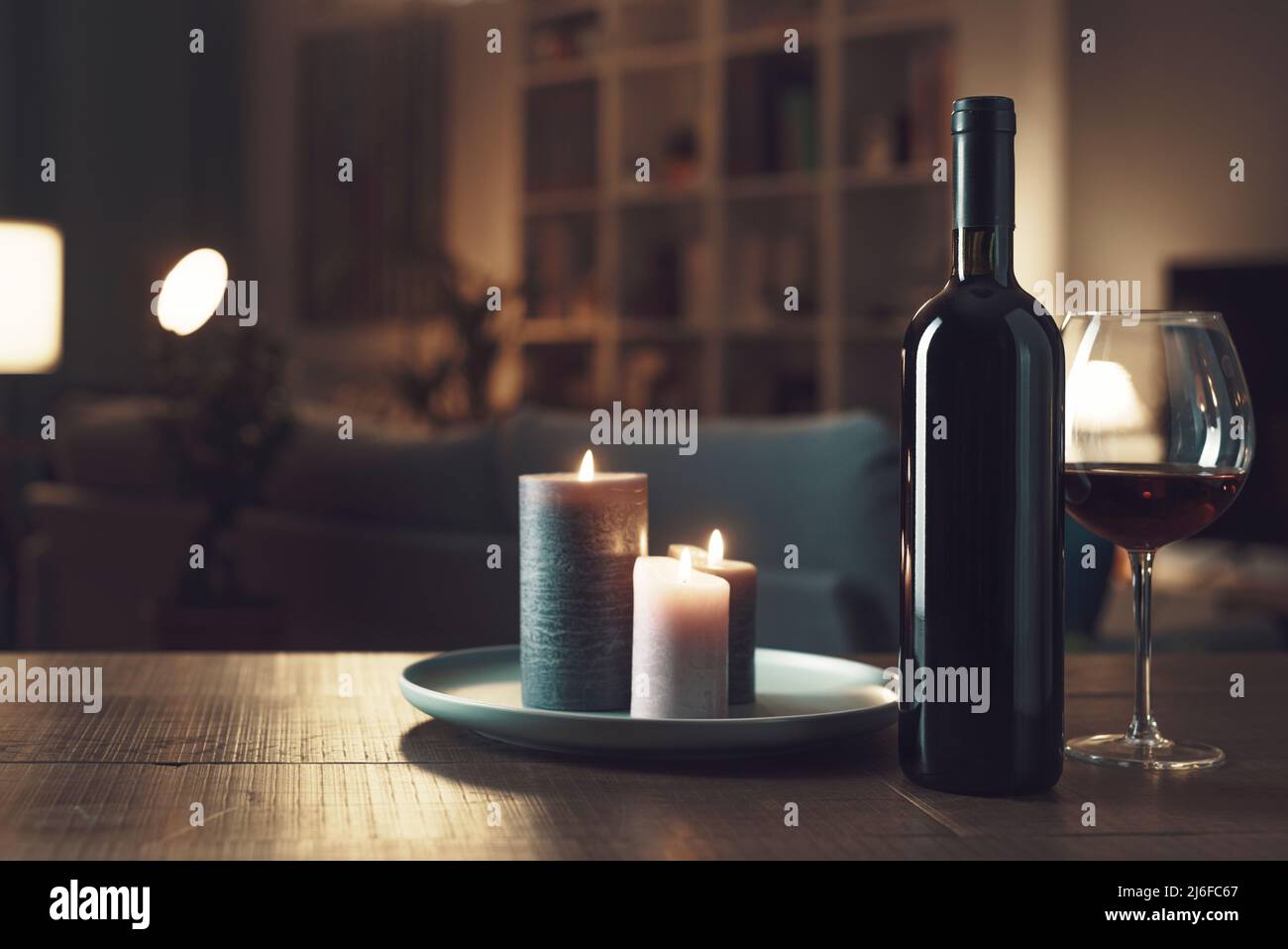 Romantic wine tasting at home with lit candles and room interior Stock ...