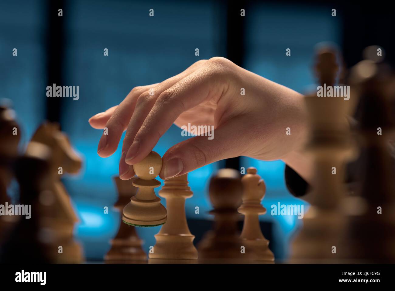 Professional player moving a pawn on the chessboard, strategy games ...