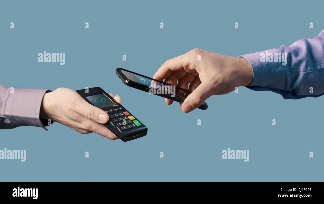 Man making a contactless transaction using his smartphone, digital ...