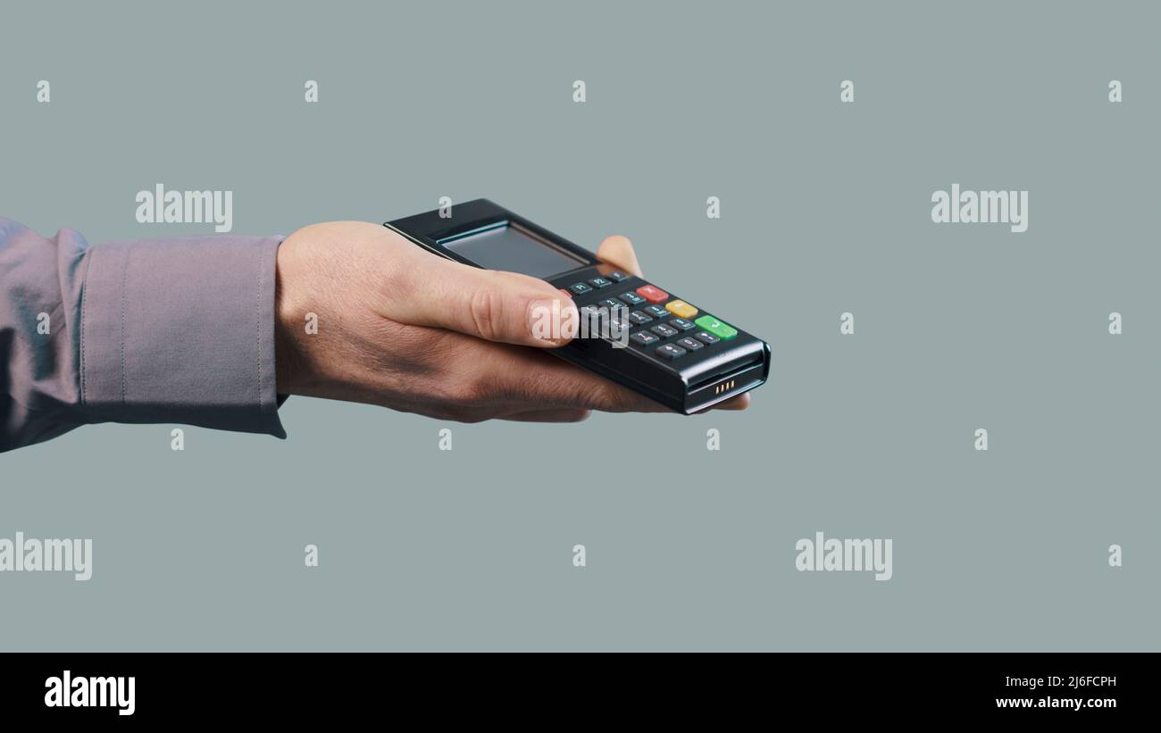 Man holding a POS terminal for digital payments, retail and e-payments ...