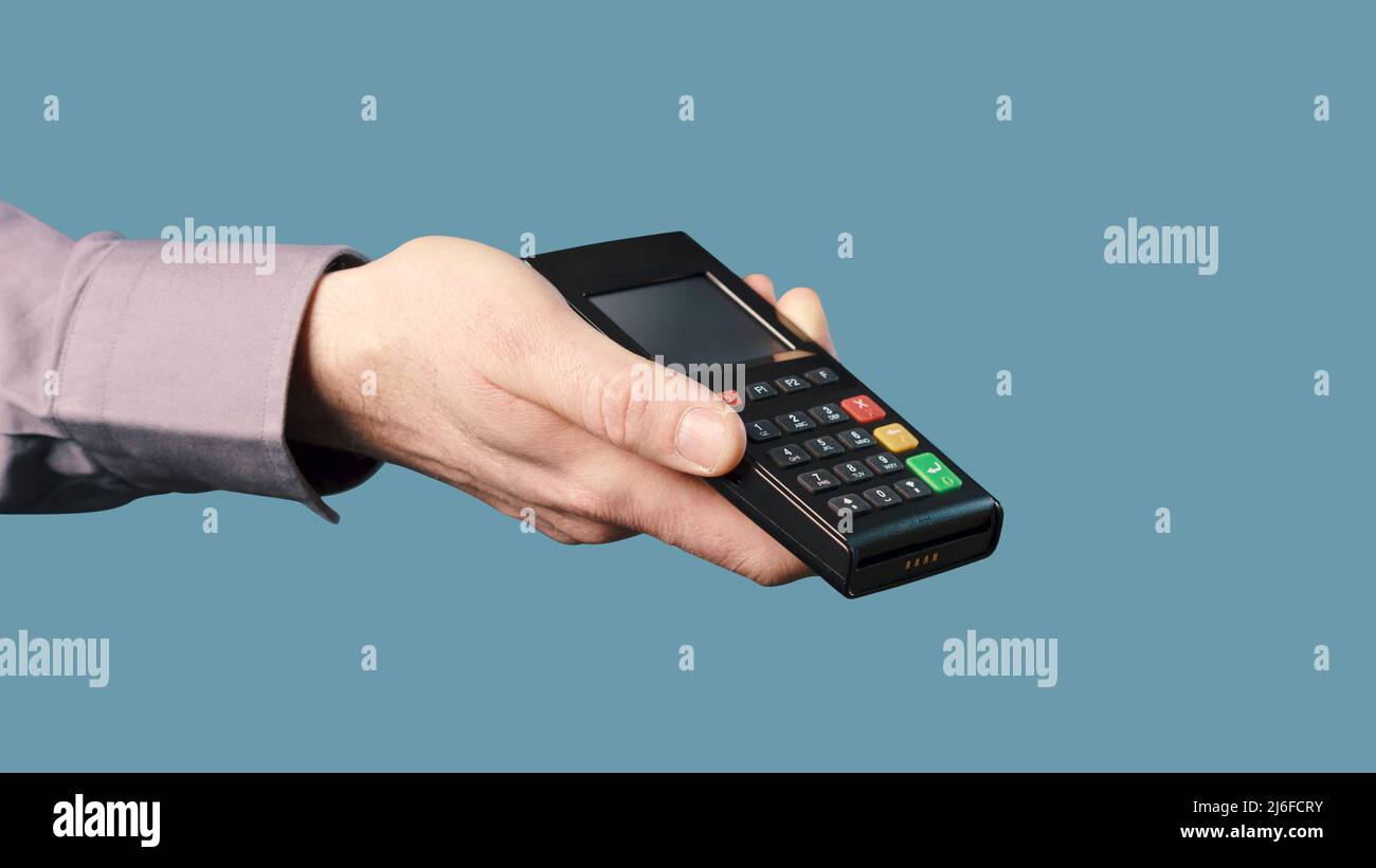 Man holding a POS terminal for digital payments, retail and e-payments ...