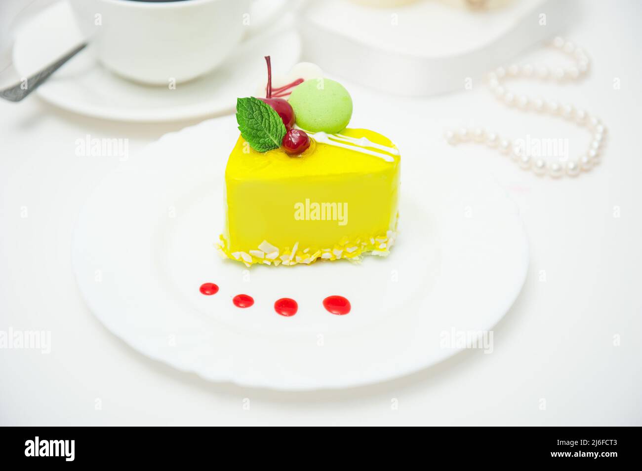 lemon yellow heart cake with cherries and cream Stock Photo - Alamy