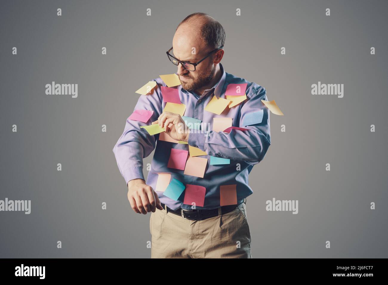 Funny man covering himself with colorful sticky notes Stock Photo - Alamy