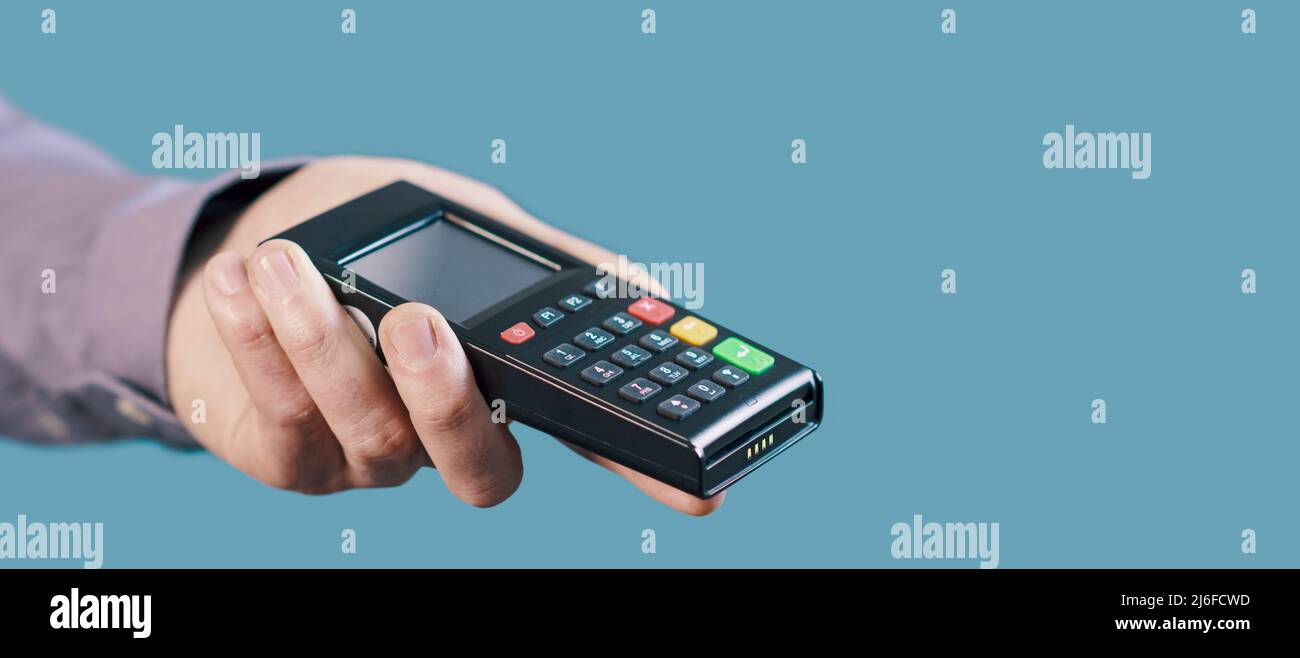 Man holding a POS terminal for digital payments, retail and e-payments ...