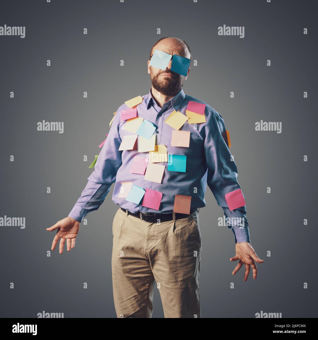 Confused disappointed businessman covered with sticky notes, he doesn't ...
