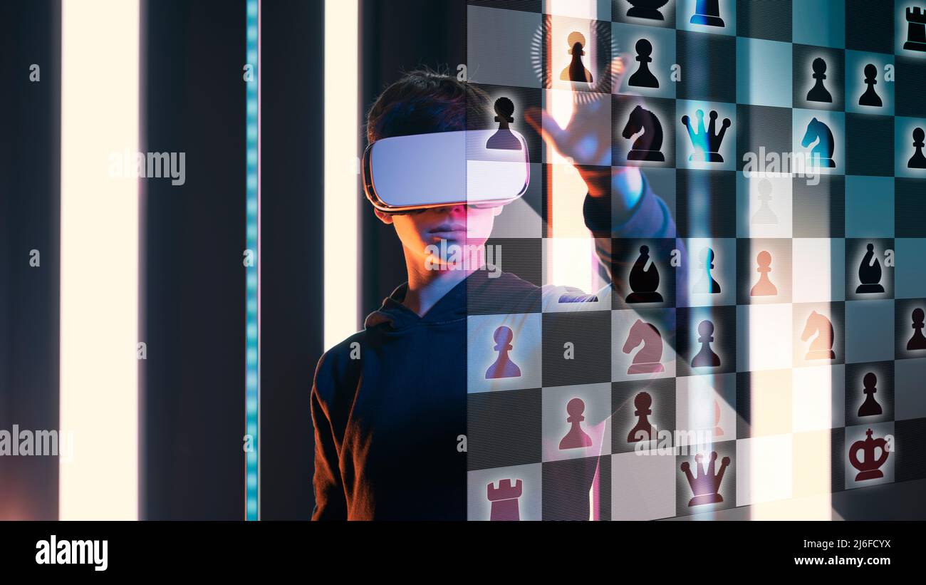 Teenager wearing a VR headset and playing chess in virtual reality, VR ...