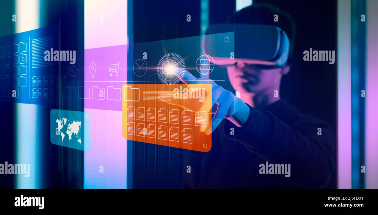 User wearing a VR headset, he is interacting with virtual screens and ...