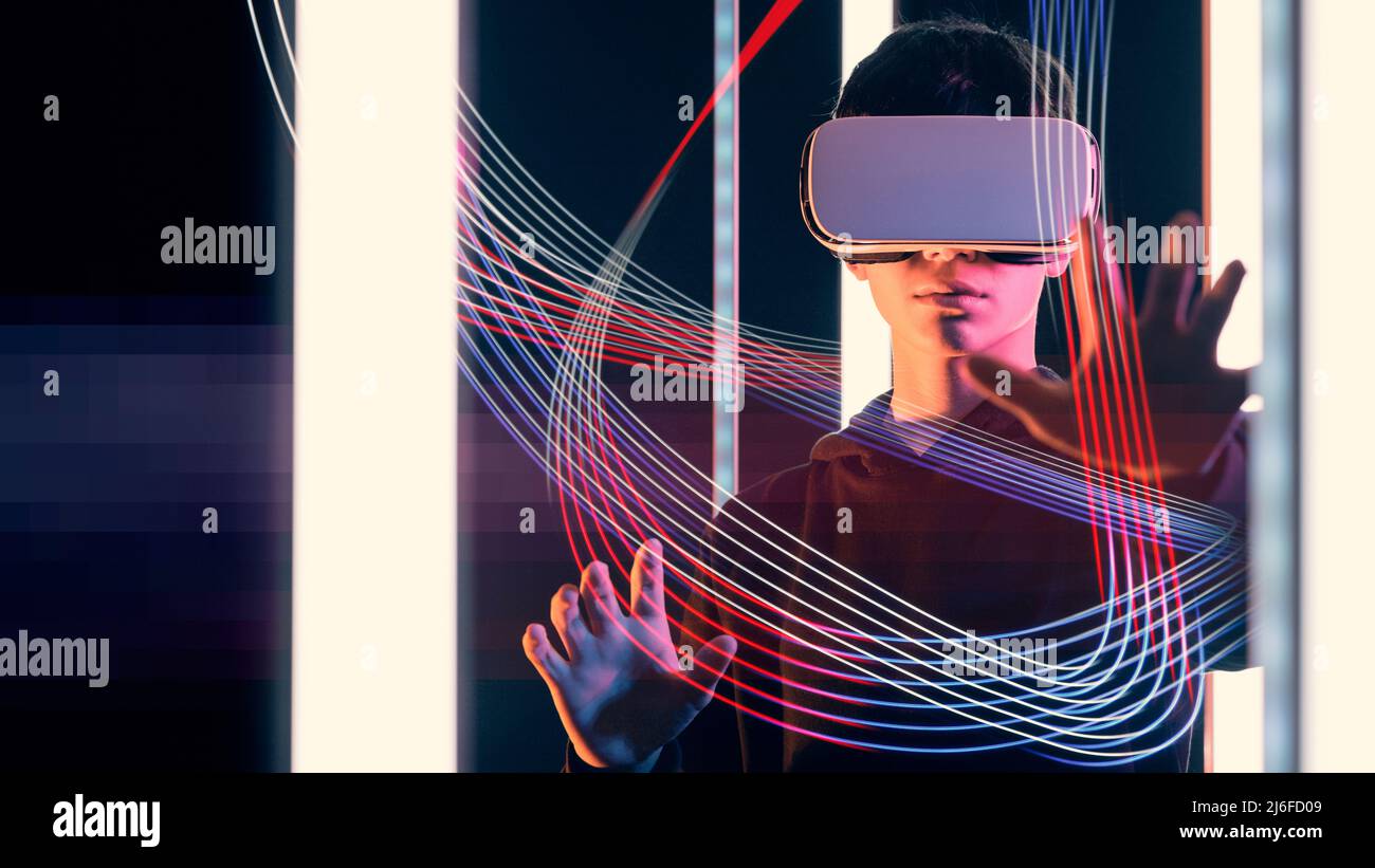 Teenager wearing a VR headset and experiencing virtual reality ...