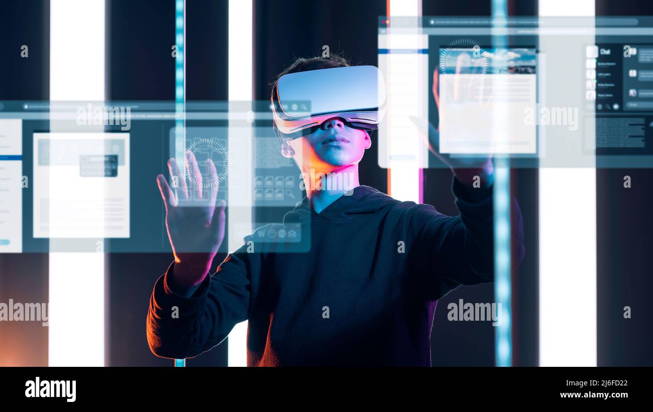 User wearing a VR headset, he is interacting with virtual screens and ...