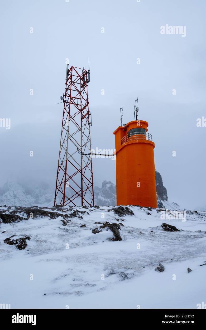 Photograph of the colorful Hvalnes Lighthouse on the southern coast of ...