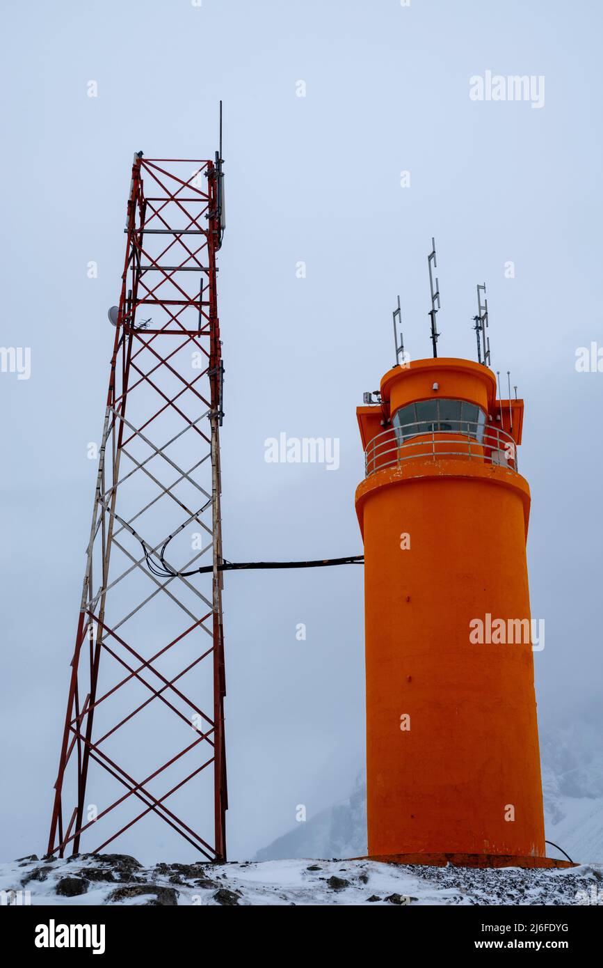 Photograph of the colorful Hvalnes Lighthouse on the southern coast of ...