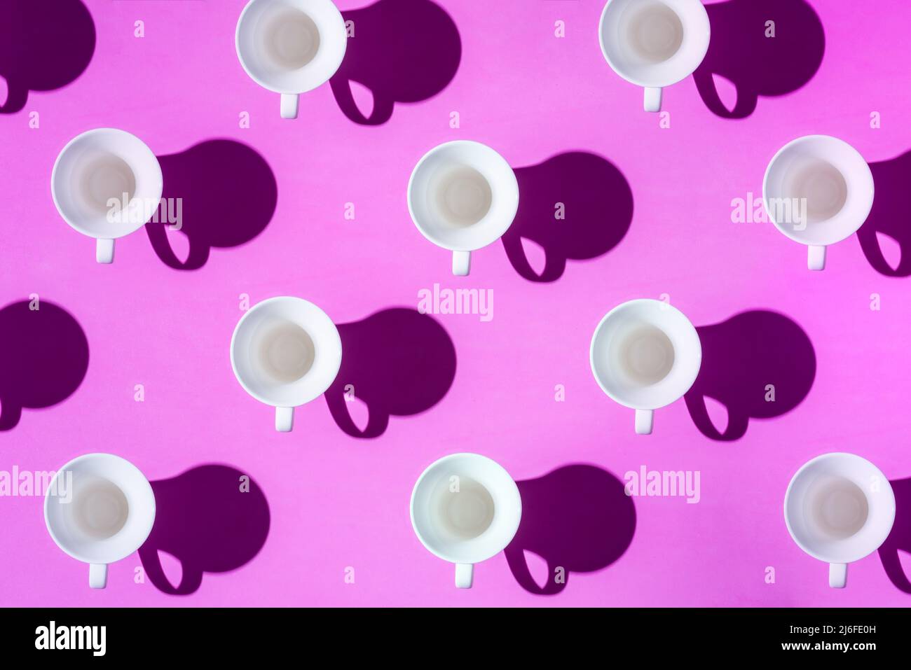 Pattern of coffee cups from a top view casting a hard shadow with the ...