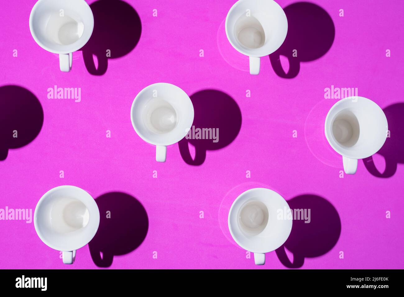 Pattern of coffee cups from a top view casting a hard shadow with the ...
