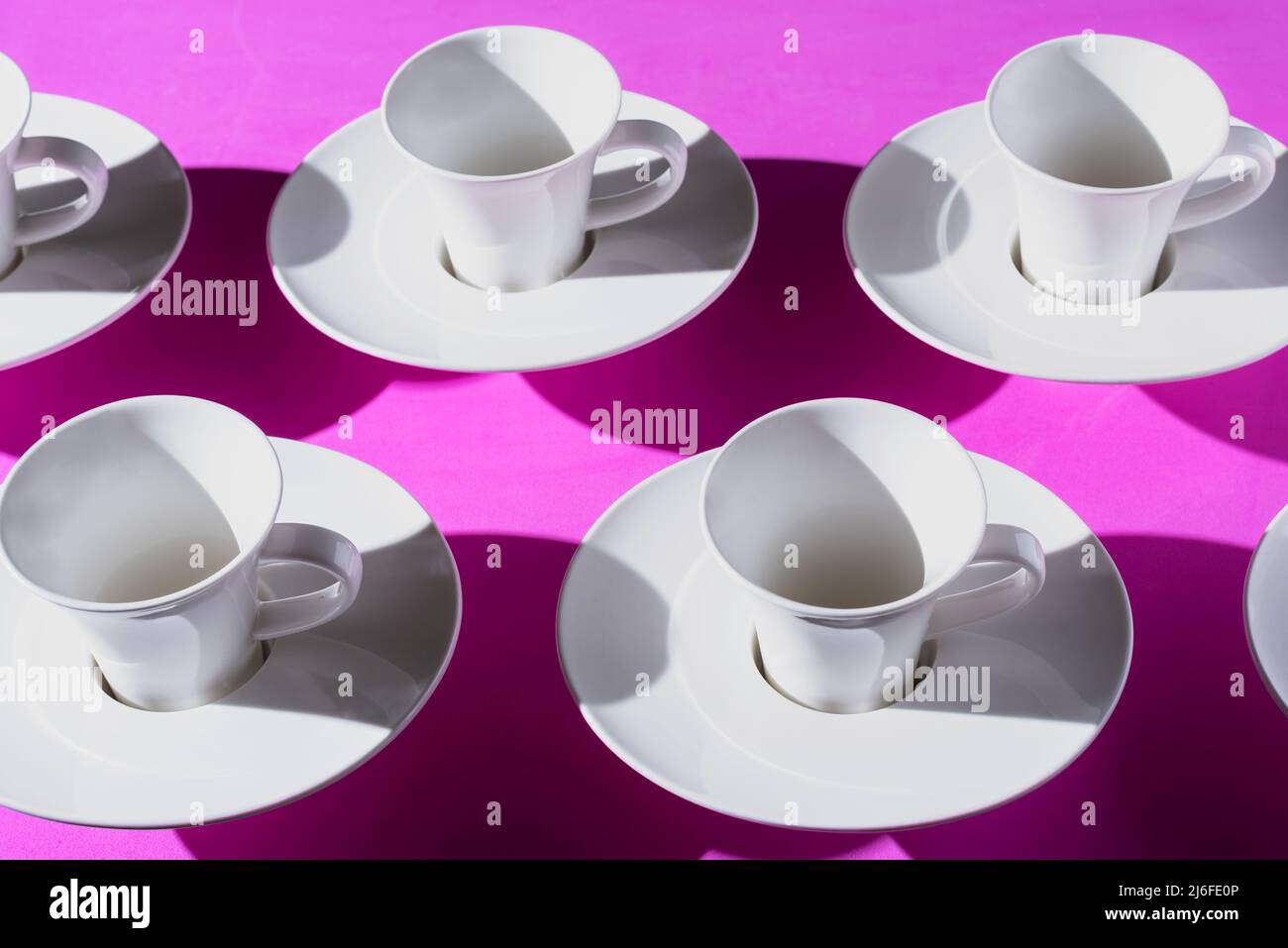 Pattern of coffee cups from a top view casting a hard shadow with the ...