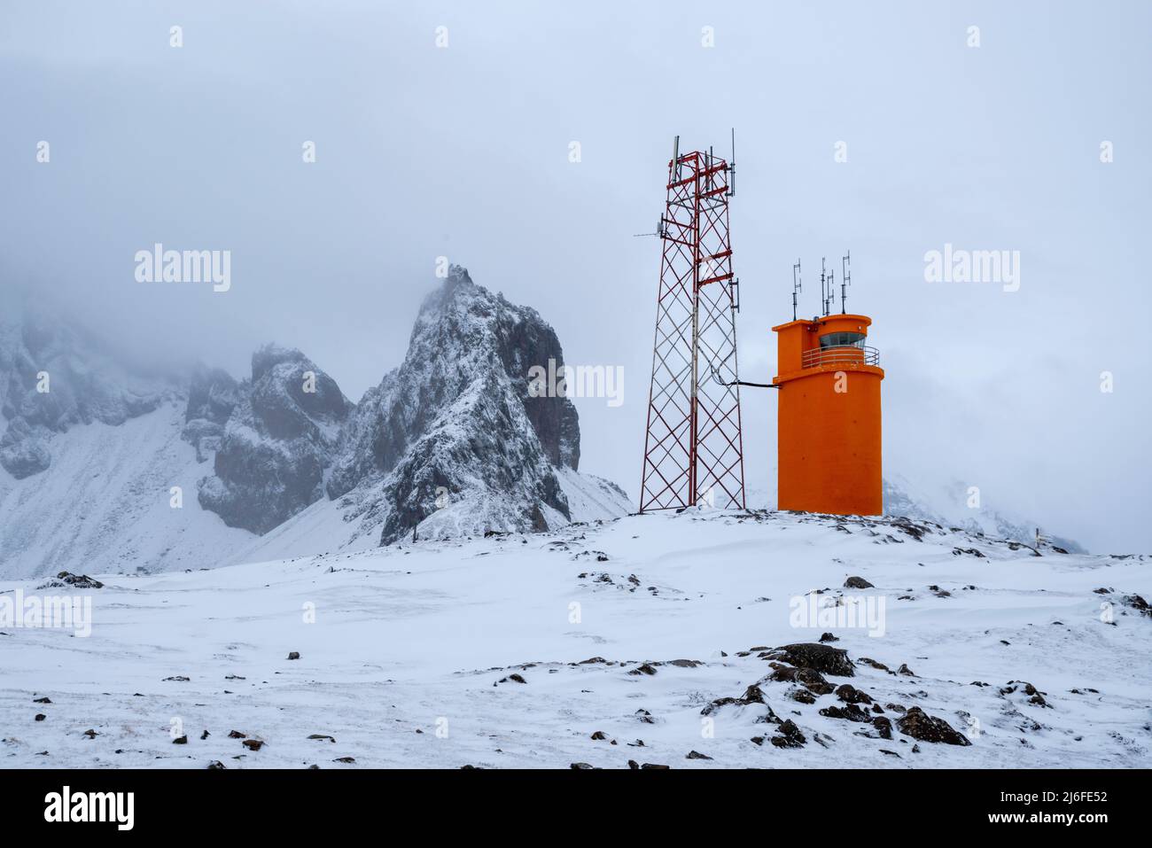 Photograph of the colorful Hvalnes Lighthouse on the southern coast of ...