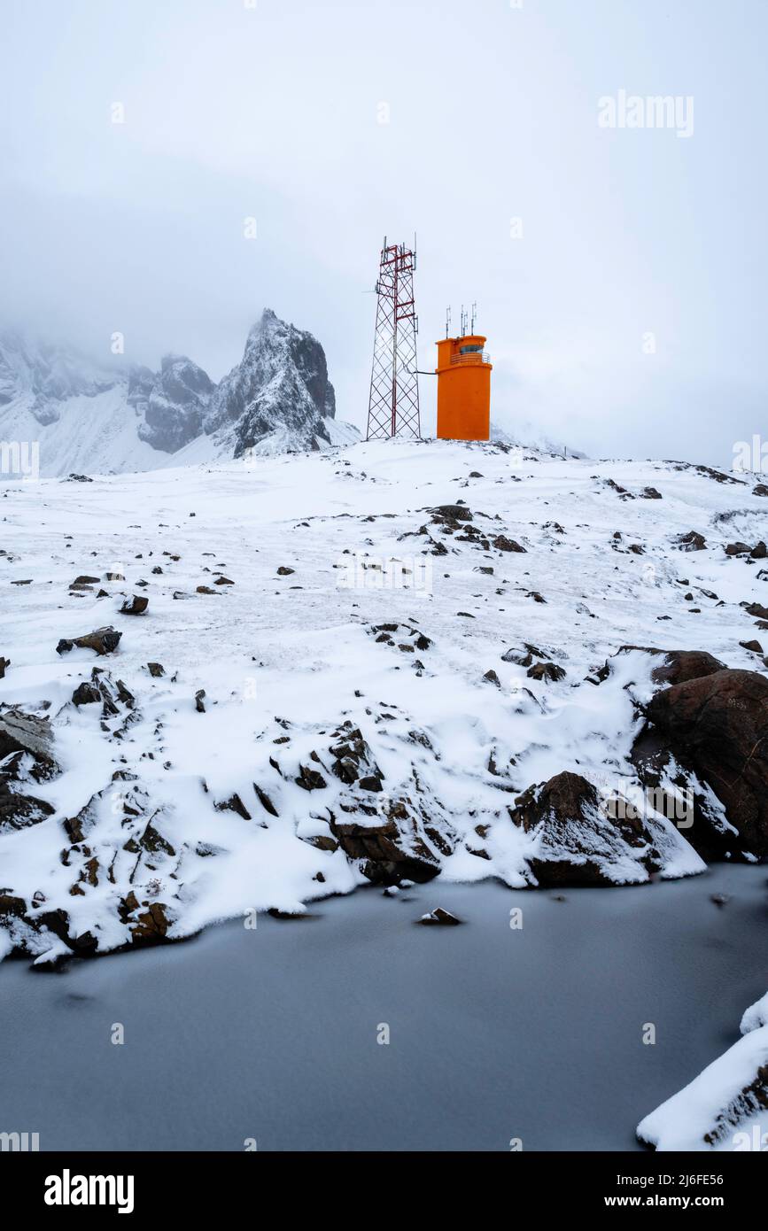 Photograph of the colorful Hvalnes Lighthouse on the southern coast of ...