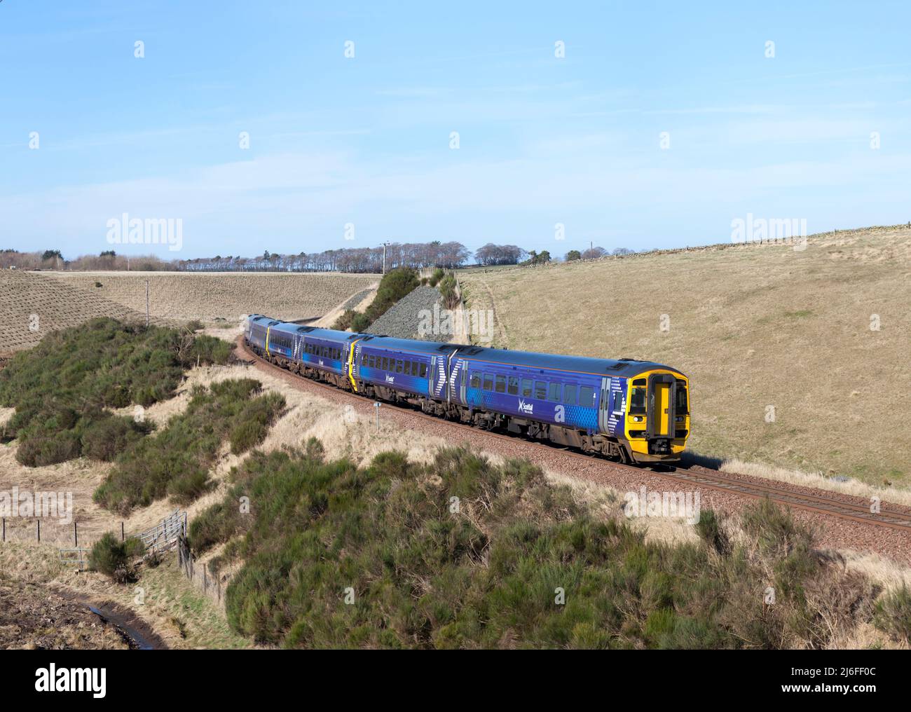 6 carriage Scotrail class 158 DMU train passing the countryside on the ...