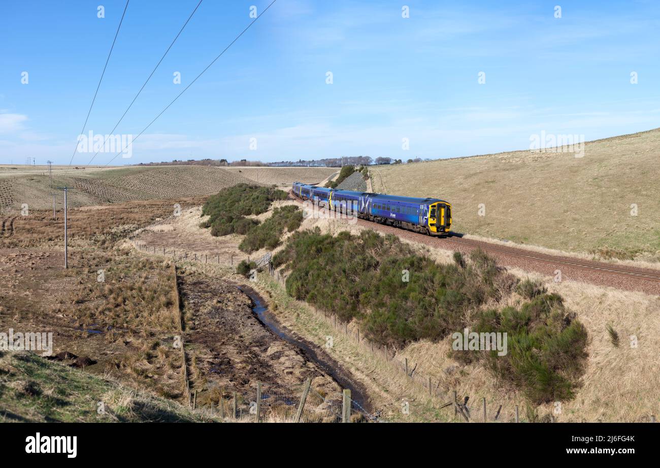 6 carriage Scotrail class 158 DMU train passing the countryside on the ...