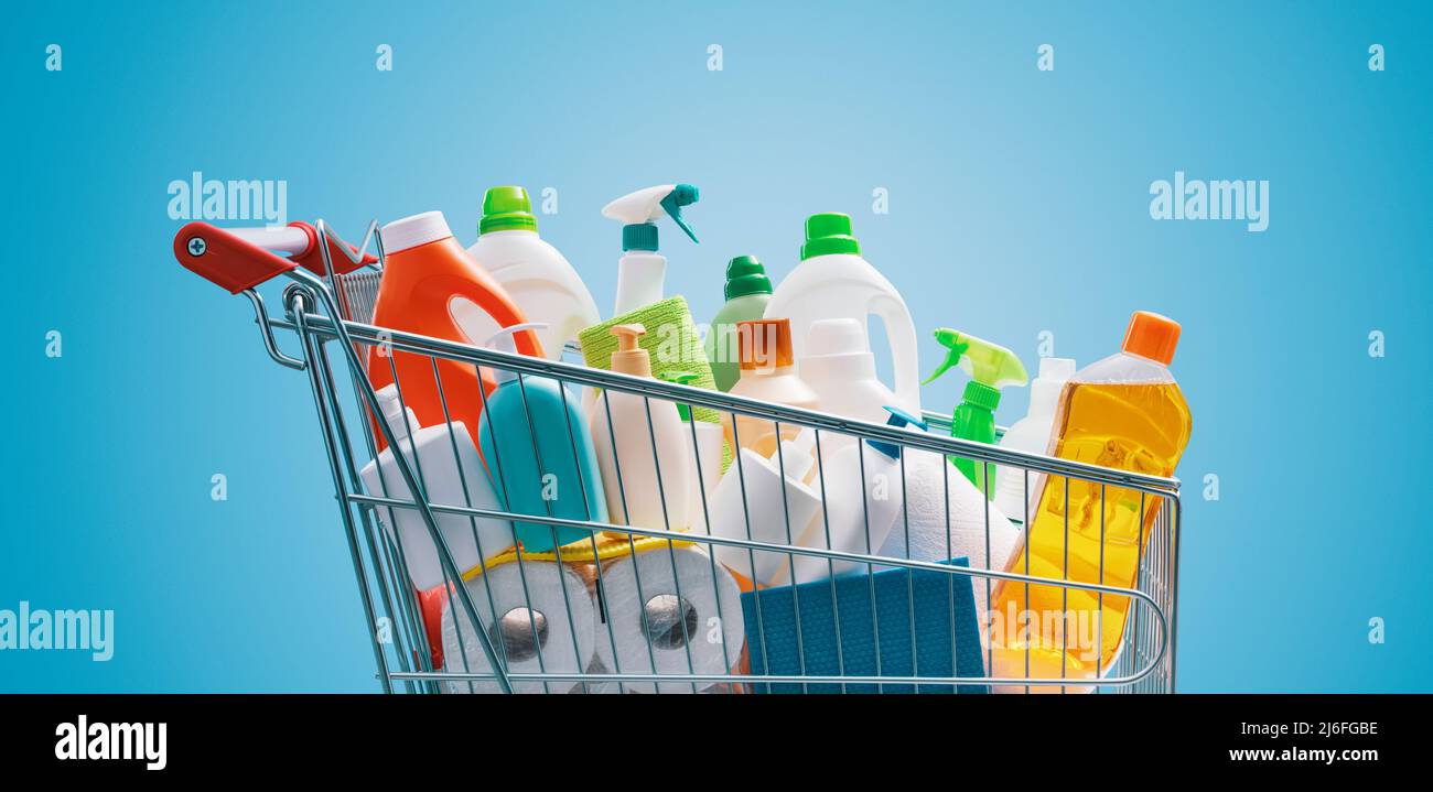 Shopping cart full of detergents, hygiene and housekeeping concept ...