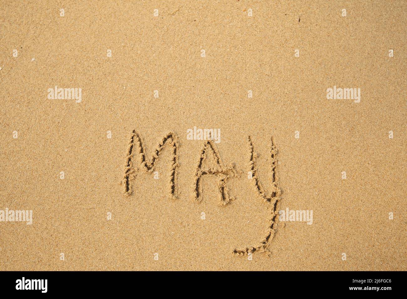 May - handwritten on the soft beach sand Stock Photo - Alamy