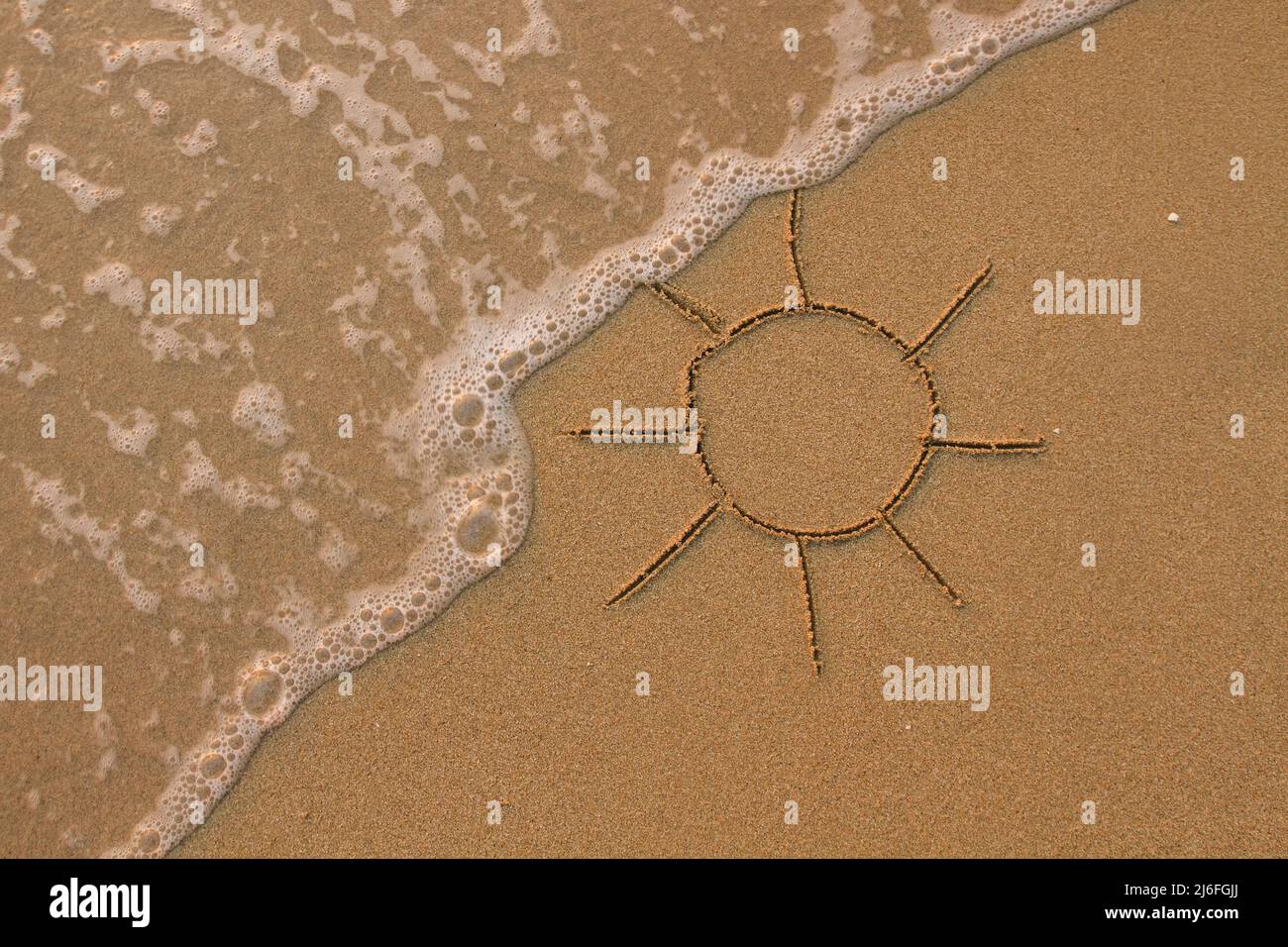 The sun is drawn handwritten on the soft beach sand Stock Photo - Alamy