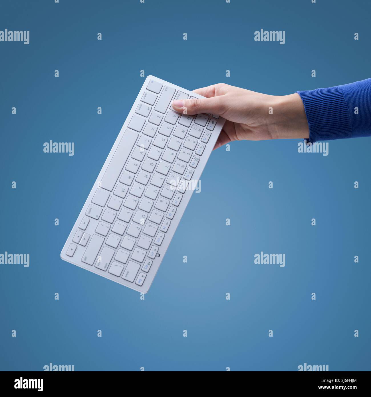 Hand holding a computer keyboard, separate waste collection and ...