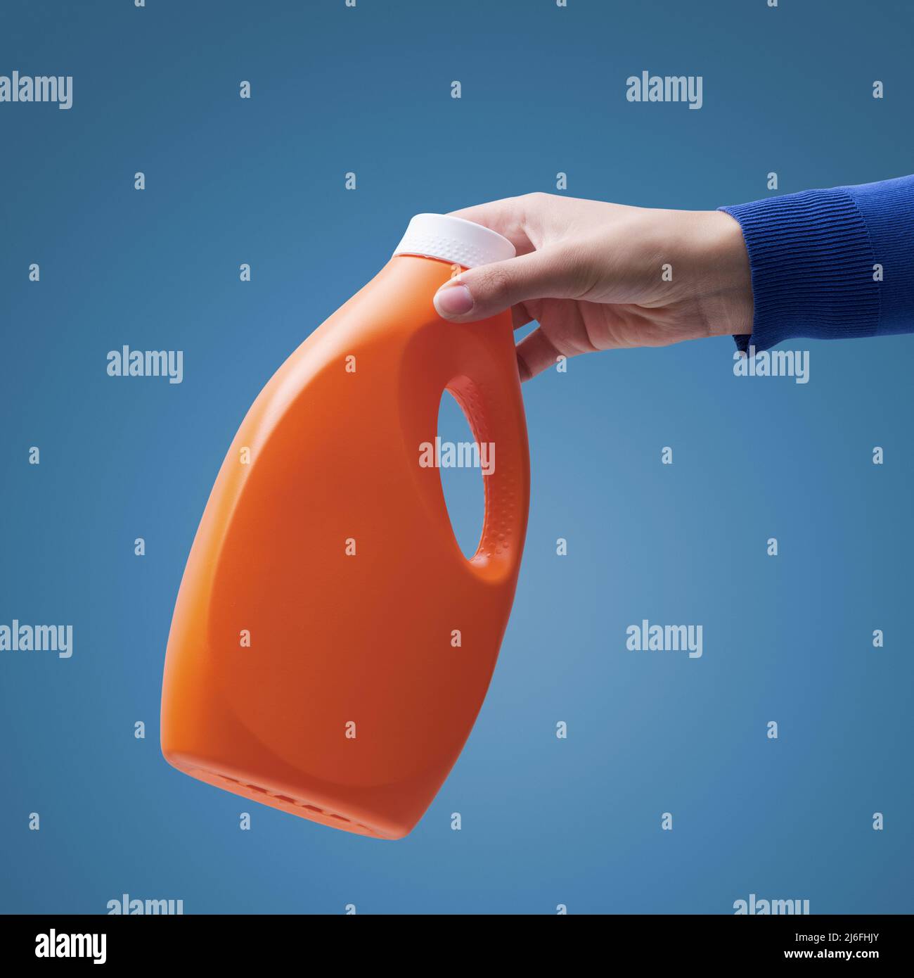 Hand holding a plastic detergent bottle, separate waste collection and ...