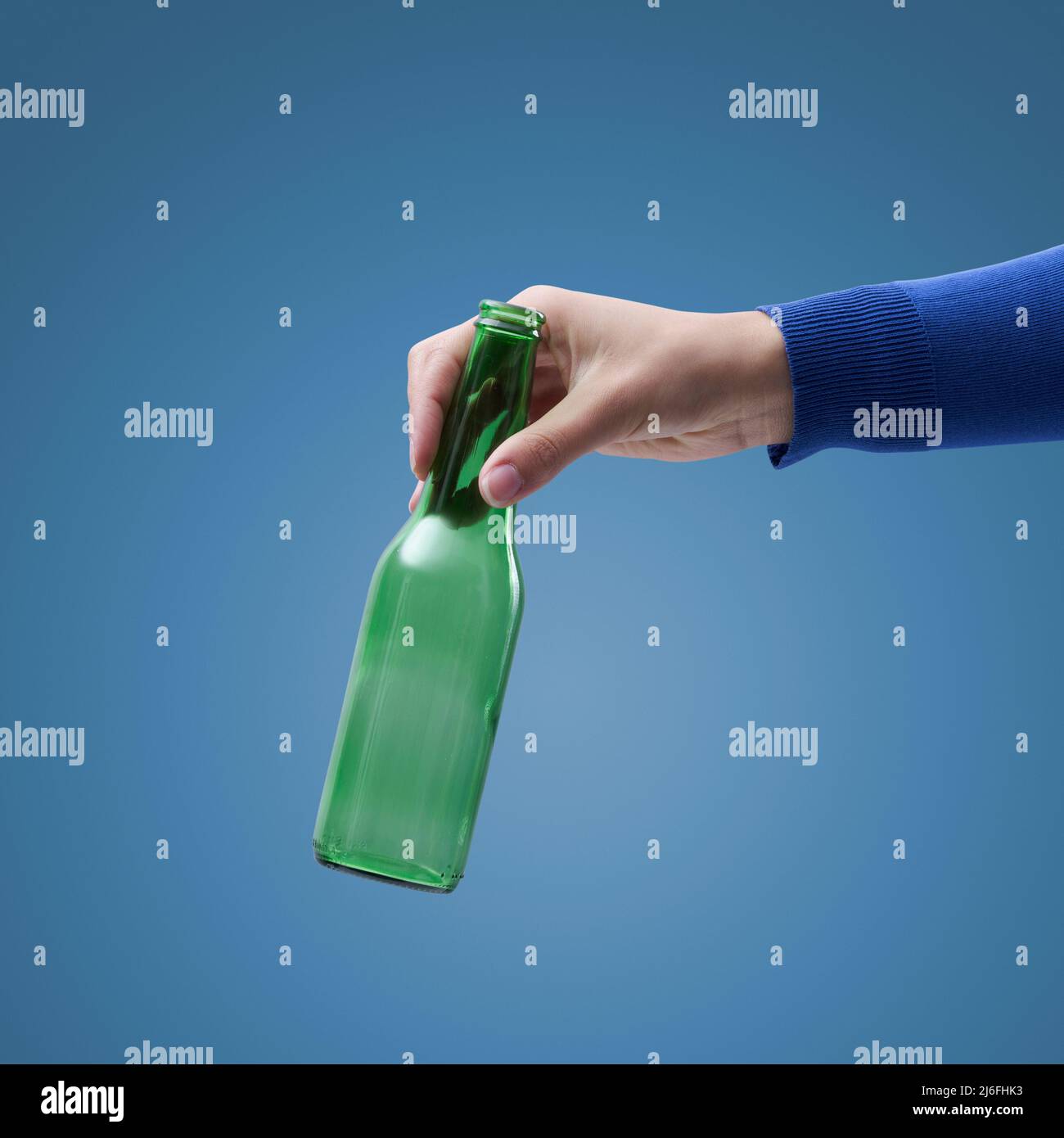Hand putting empty glass bottle hi-res stock photography and images - Alamy