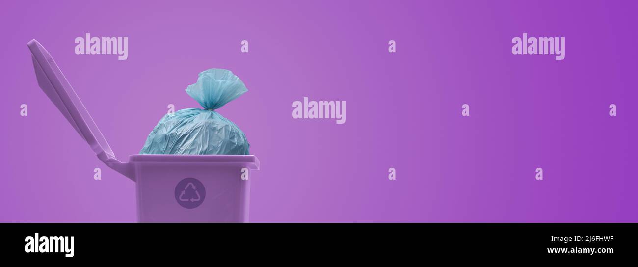Garbage bag in a open trash bin, waste management and recycling concept ...