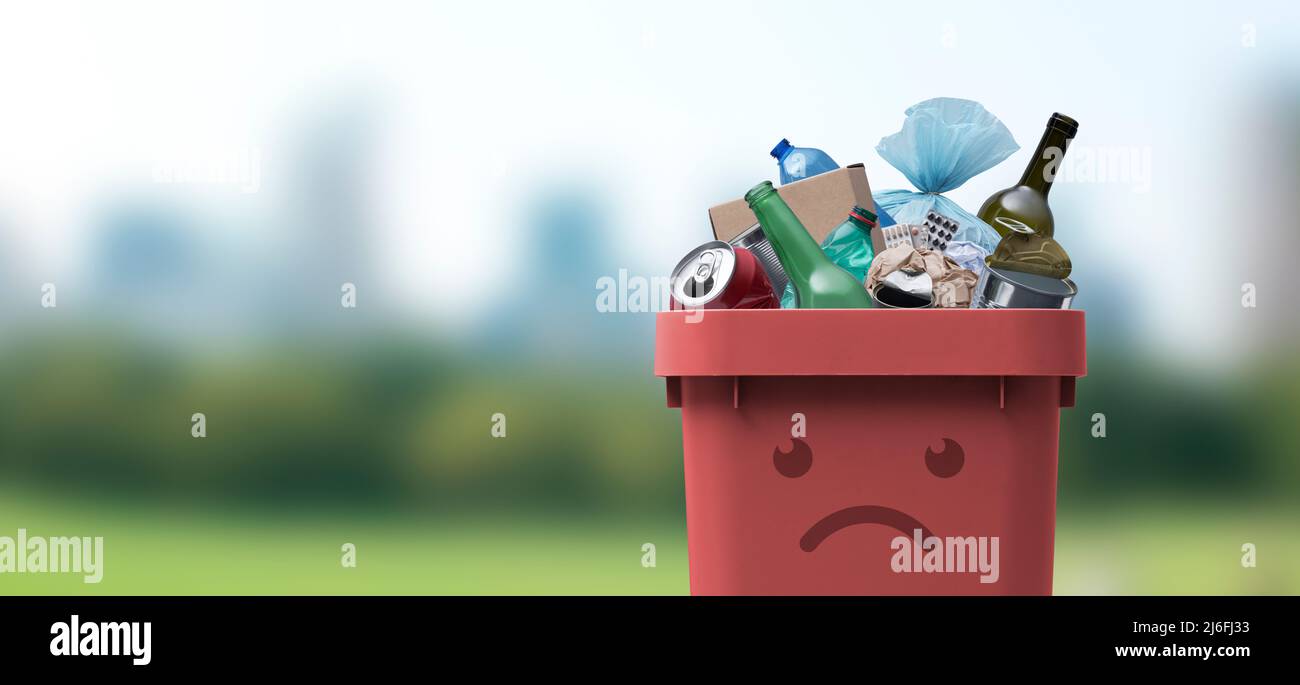 Sad garbage can character full of undifferentiated waste, improper ...