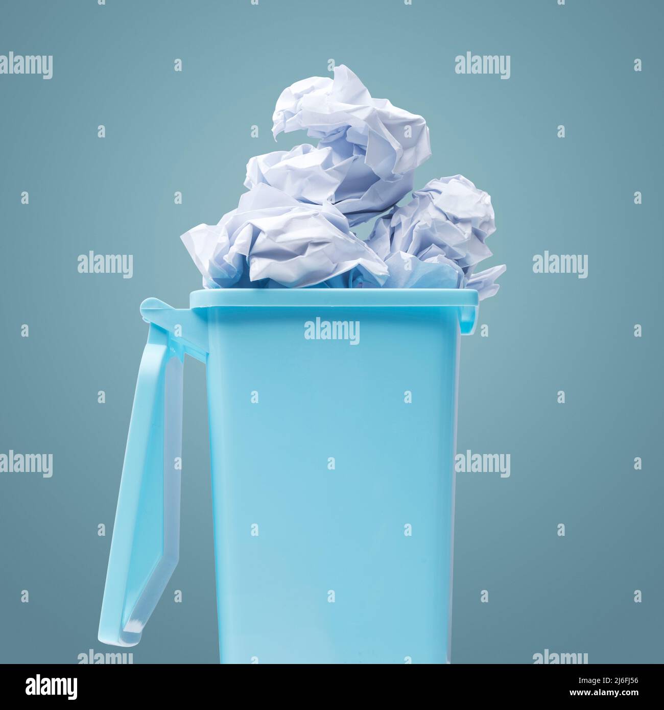 Small garbage can full of crumpled paper, recycling and separate waste ...