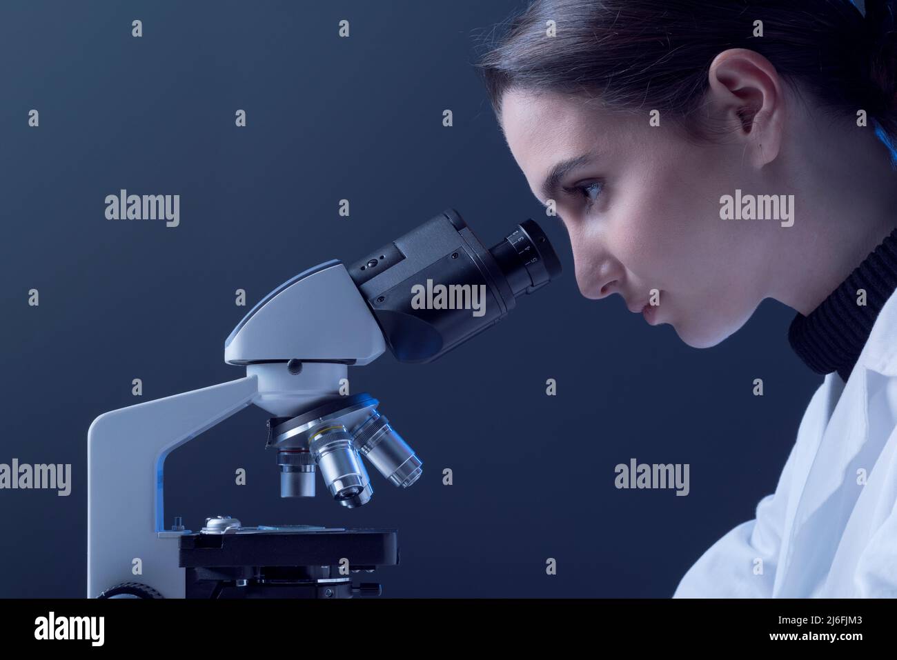 Watching through microscope hi-res stock photography and images - Alamy