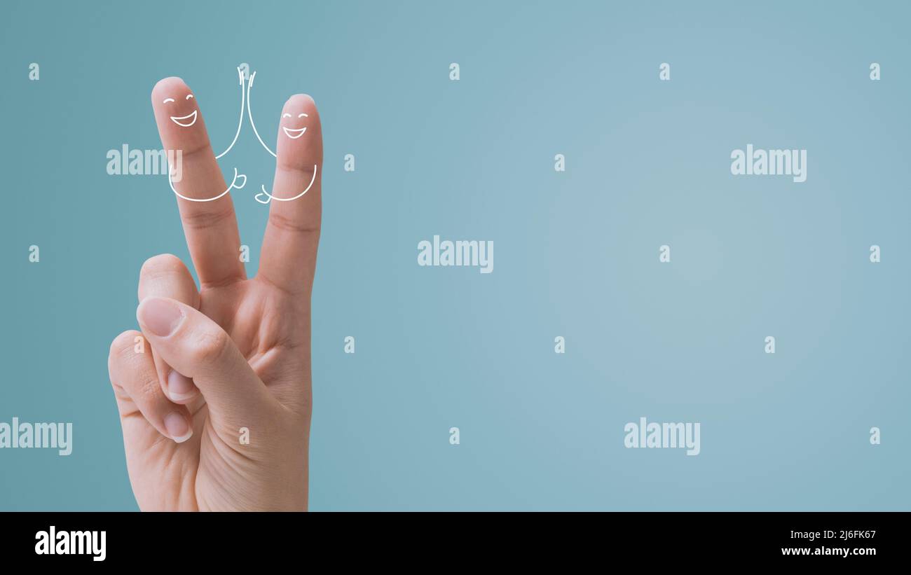 Female hand making a V-sign and cute stick figures giving a high five ...