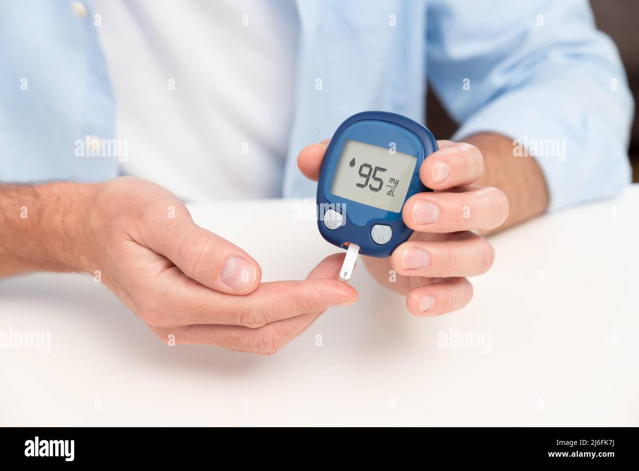 Man measures his blood sugar. Glucometer, blood sample test, diabetes ...
