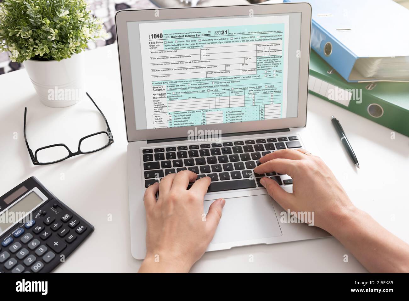 US Individual income tax return. Accountant working with US tax forms ...