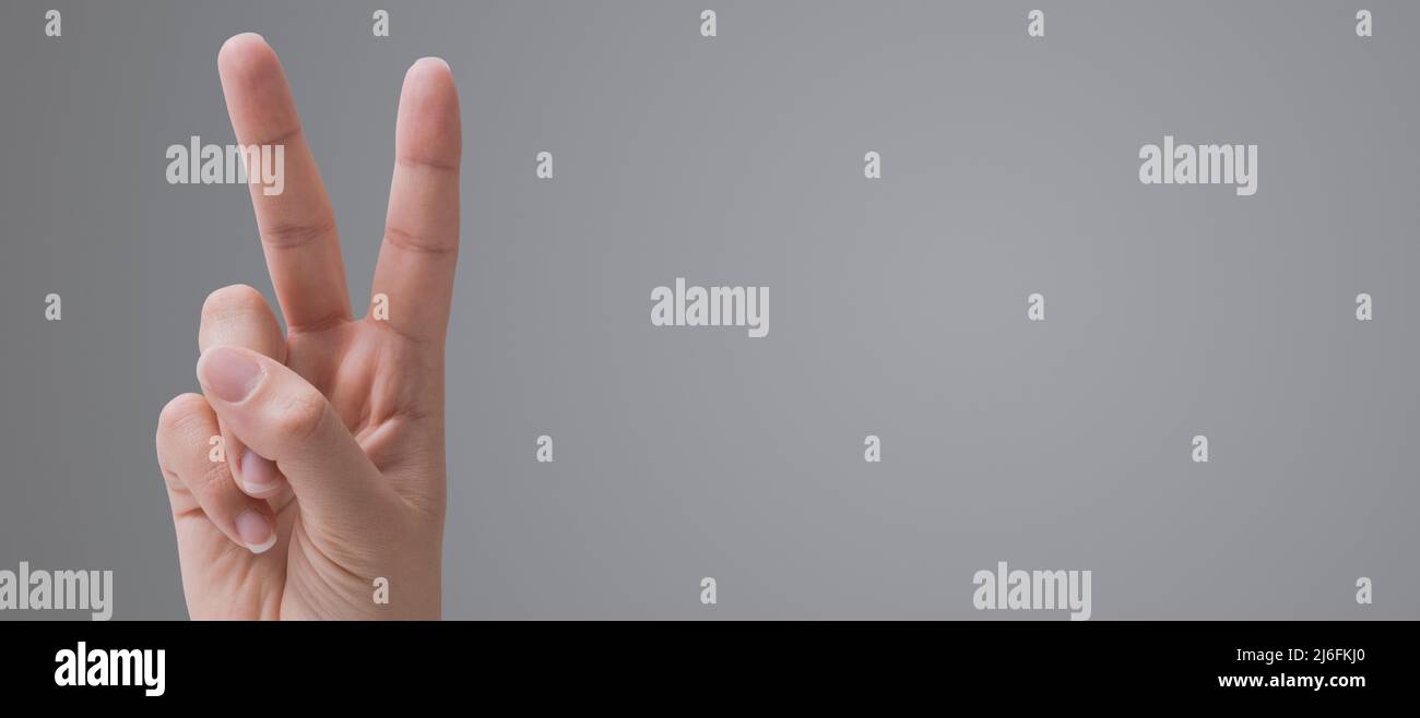 Female hands making a V-sign, gesturing and communication concept ...