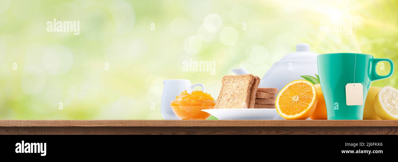 Healthy delicious tea break outdoors in the garden: tea, bread and jam ...