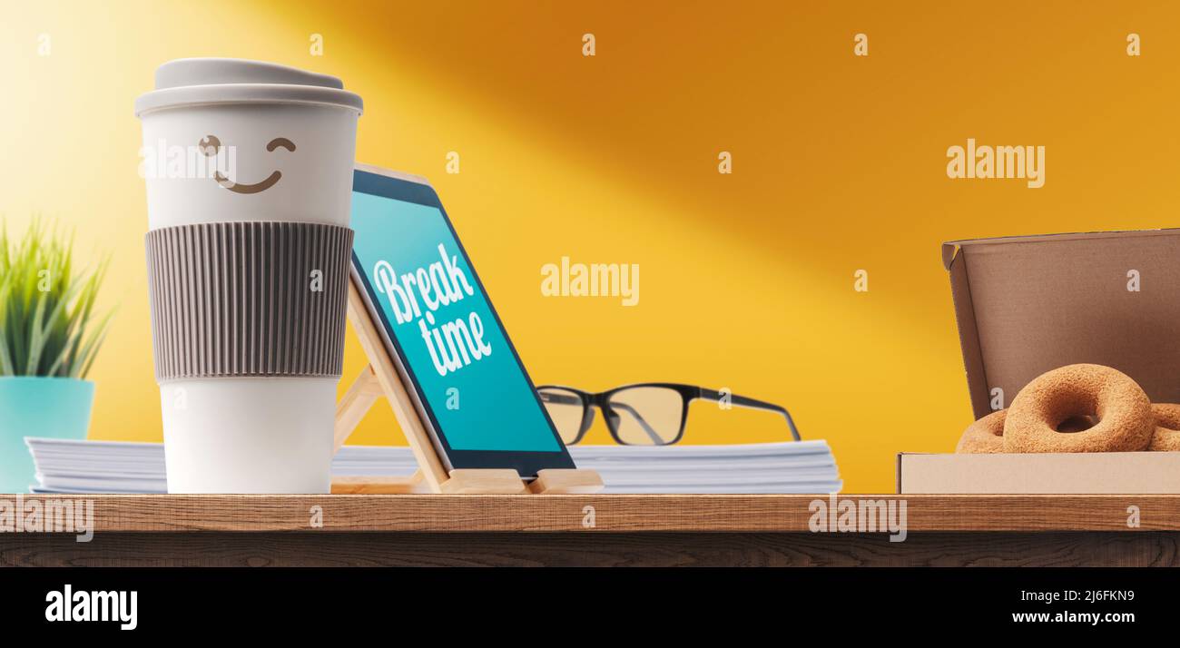 Break time in the office: smiling coffee cup and delicious donuts on ...