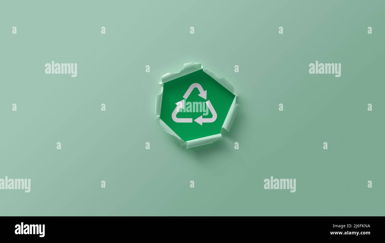 Torn green paper and recycling symbol in the round hole, sustainability ...