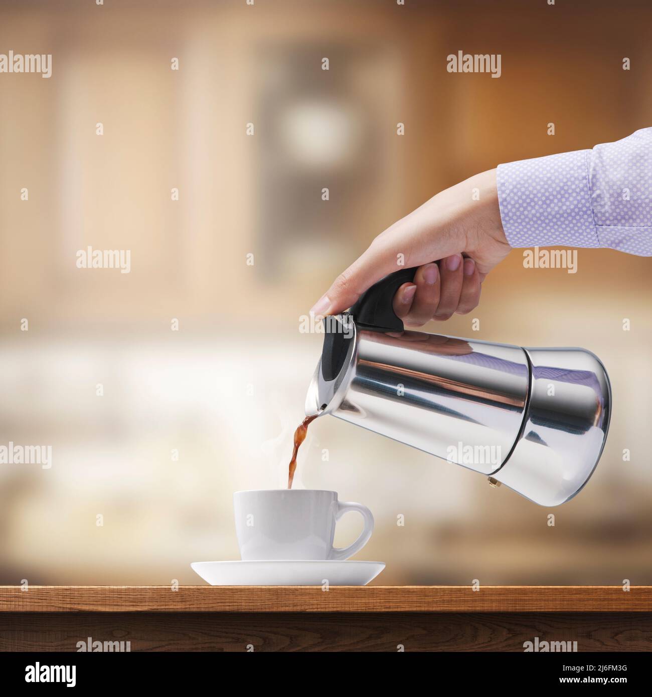 Woman having a coffee break, she is pouring hot coffee in a cup Stock ...