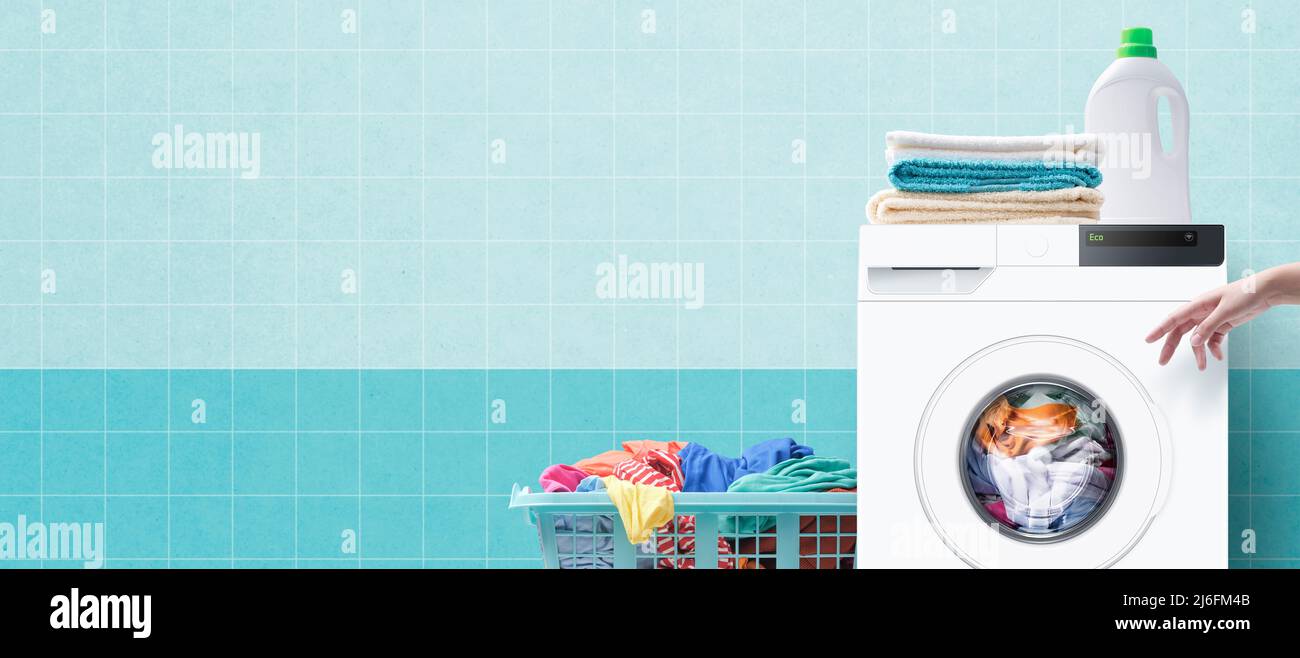 Full washing machine and laundry detergents, household chores concept ...