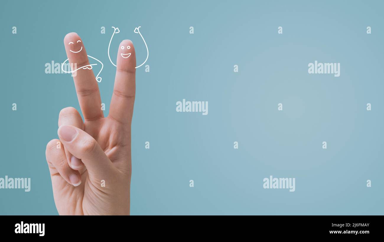 Female hand making a V-sign and cute stick figures smiling Stock Photo ...
