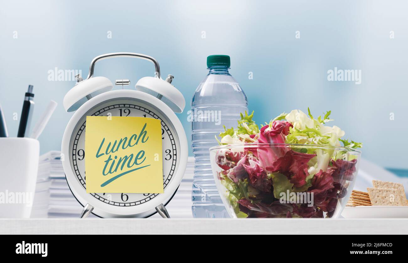 Healthy salad bowl and lunch time sticky note reminder: lunch break at ...