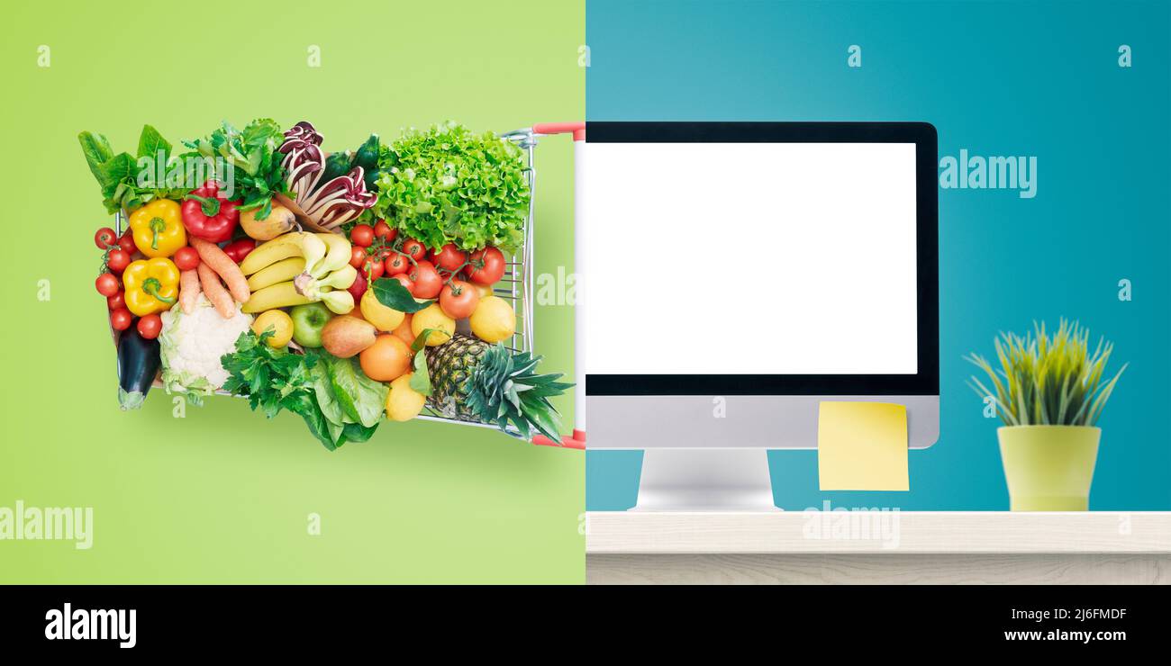 Online grocery shopping: shopping cart full of fresh vegetables and ...