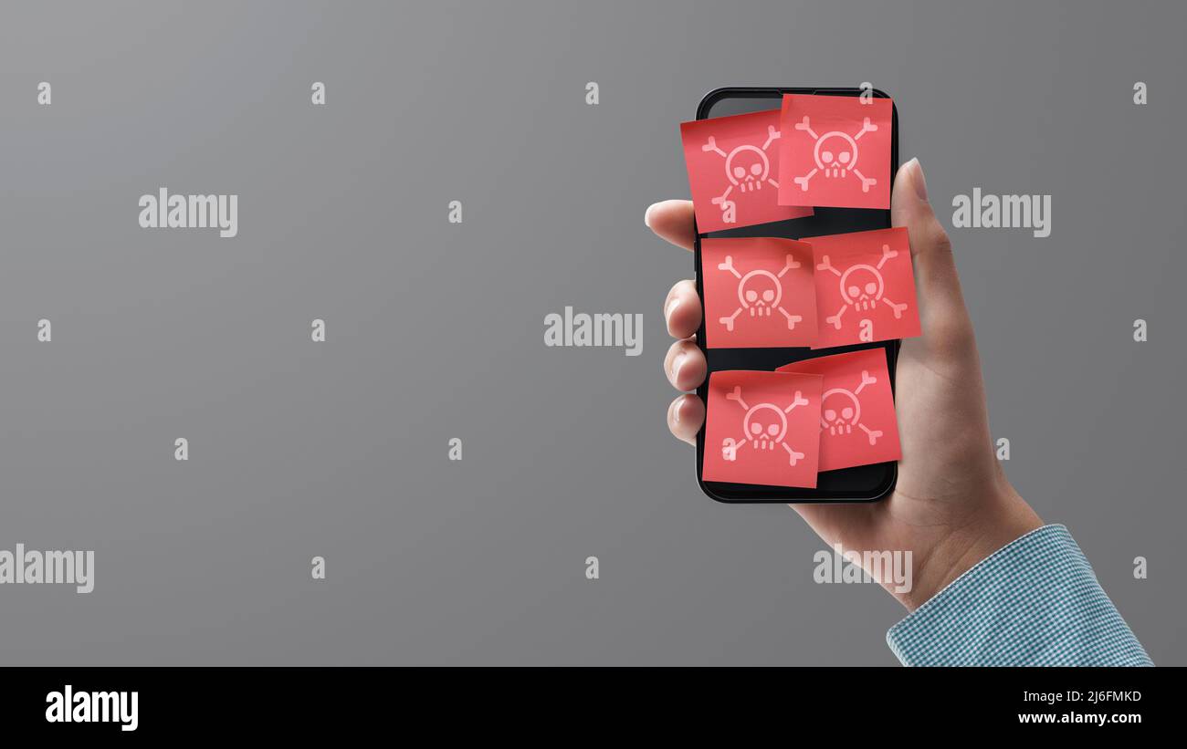 Hand holding a smartphone infected with viruses and malware ...