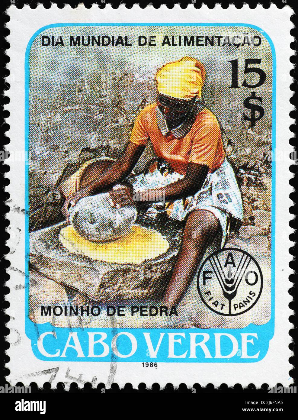 African woman grinding seeds in a traditional way on postage stamp ...