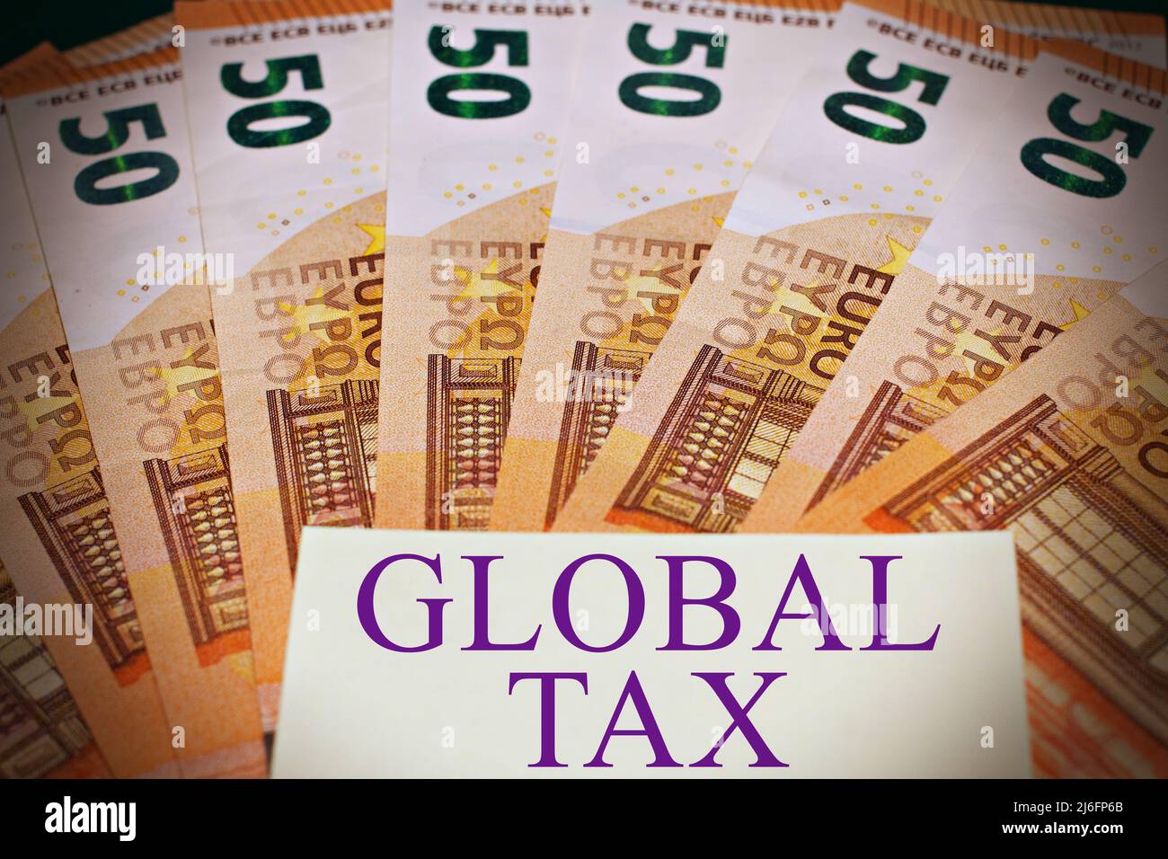 Close up of European banknotes of 50 Euros and the text "Global Tax ...