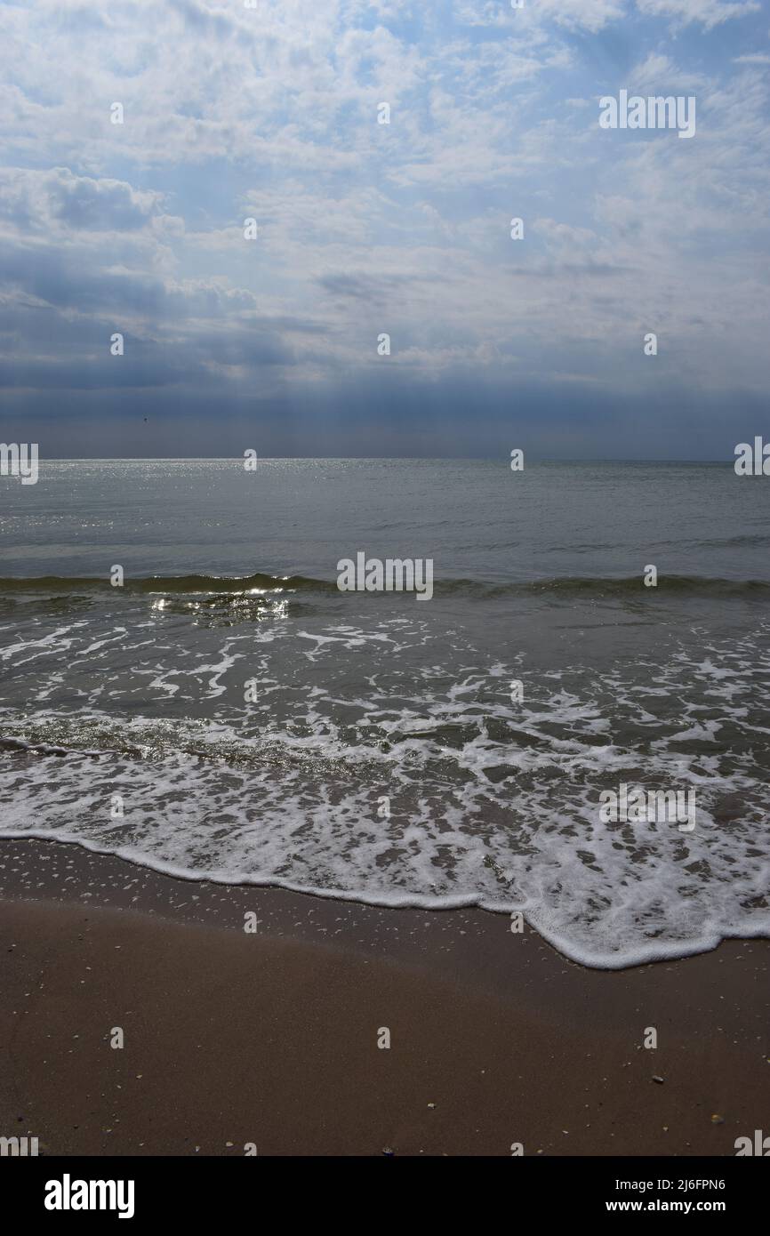 Beautiful landscape - turquoise colored sea water, sand, sky. The waves ...