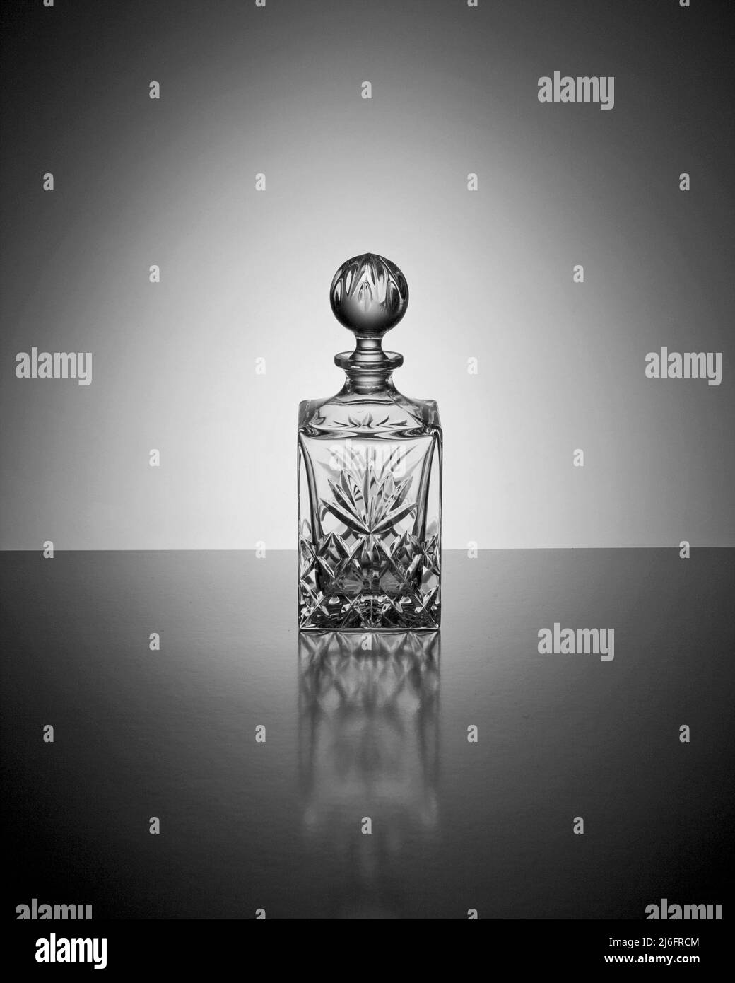 Decorative Glass Decanter On A Reflective Surface Stock Photo - Alamy